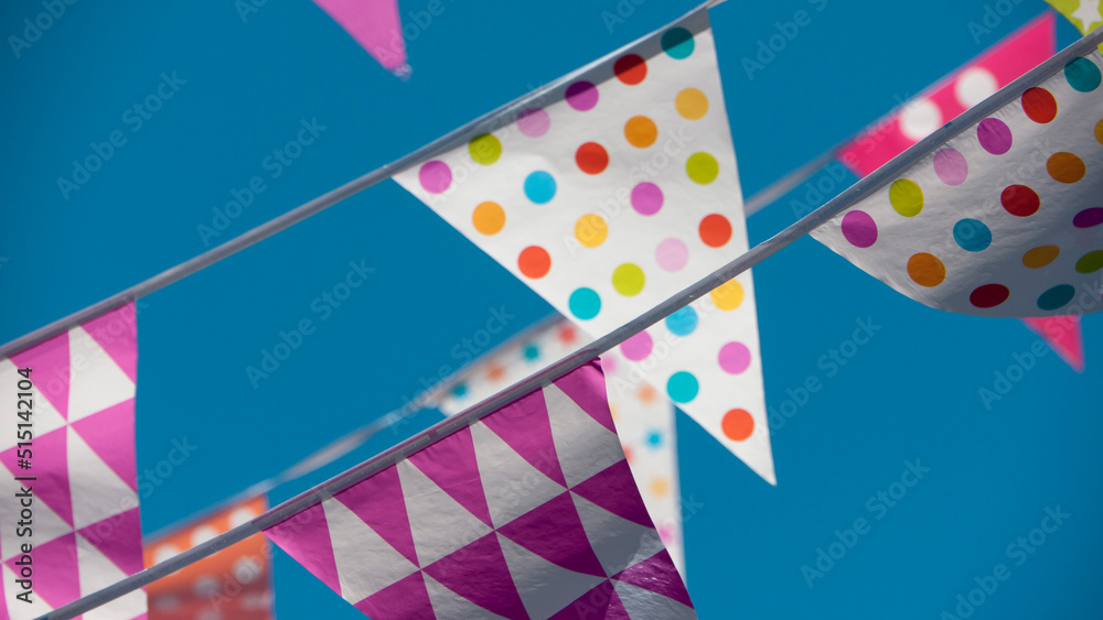 Foto de Banderines triangulares de fiesta de colores sobre cielo azul ...