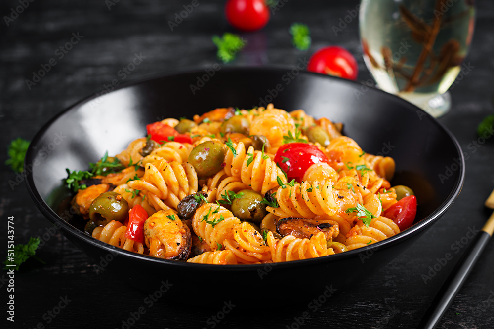 Classic italian pasta fusilli marinara with mussels, green olives and ...