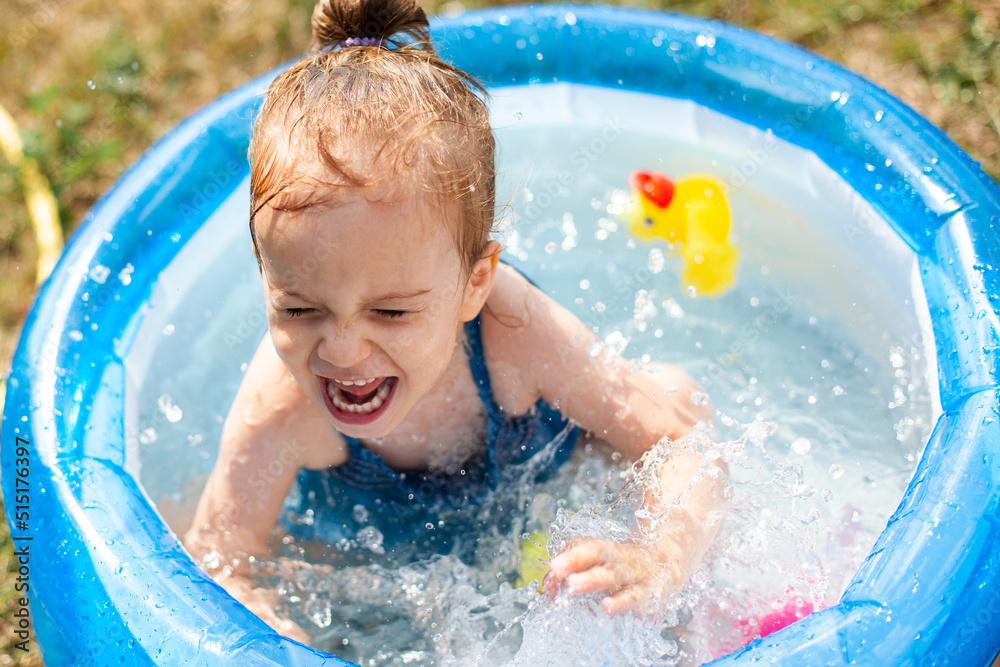 Cute little girl having fun in the pool in the garden Stock Photo ...