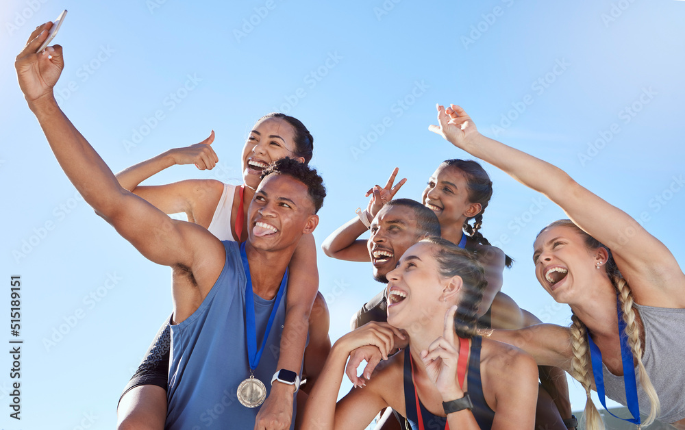 Group of diverse olympic athletes taking a selfie while having fun and ...
