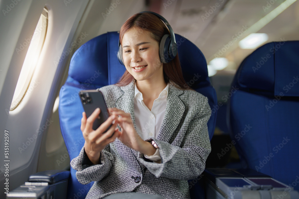 portrait of A successful asian business woman in a plane sits in a ...