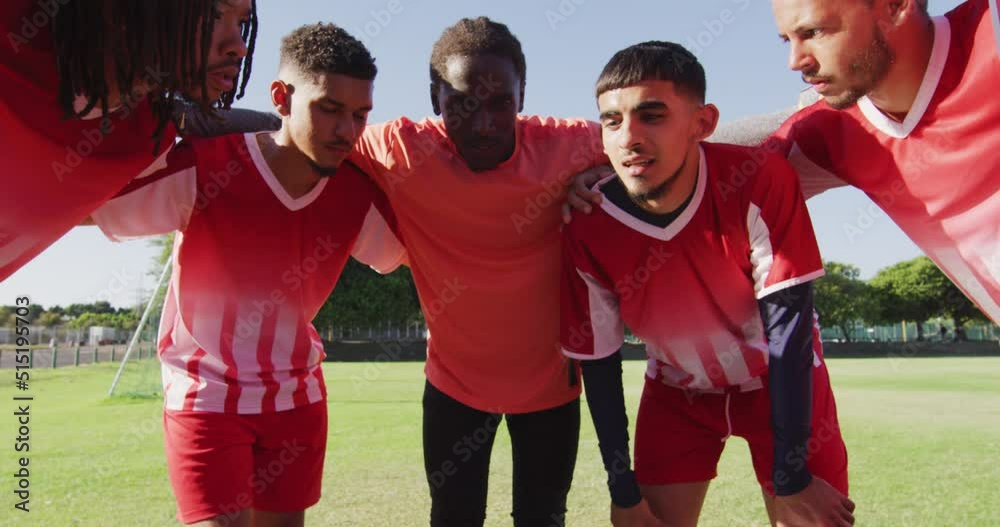 Video of diverse group of male football players on field,discussing ...