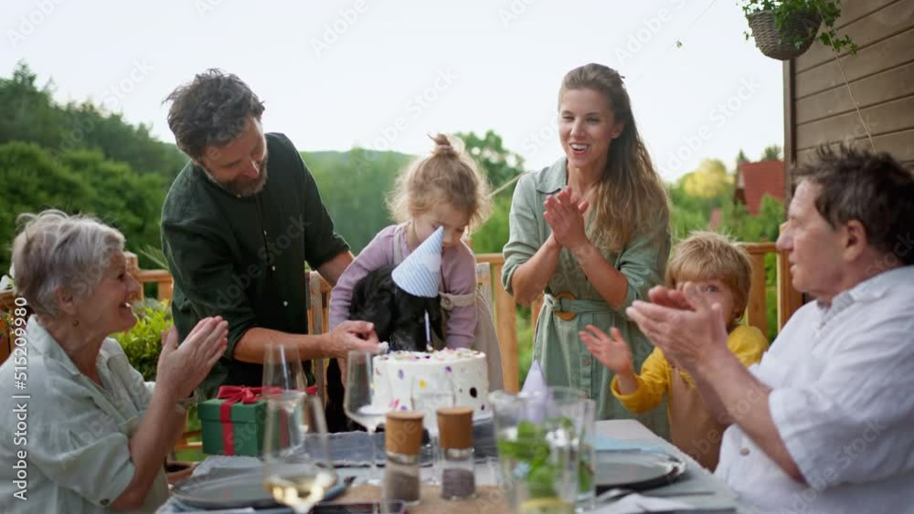 Multi generation family celebrating birthday of little girl and having ...