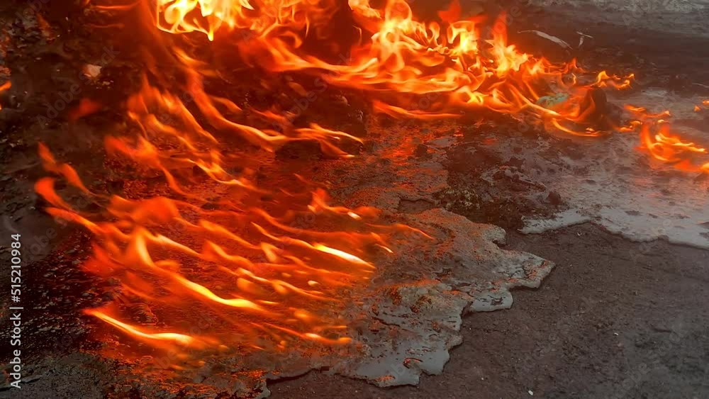 Solidified lava burns in fire. Pollution of ecology and environment ...