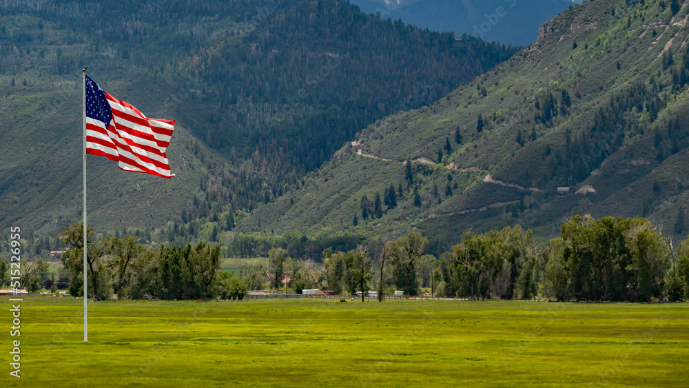 American flag proudly flying over a pasture high in the San Jaun ...