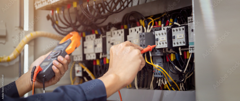 Electrical engineer using measuring equipment to checking electric ...