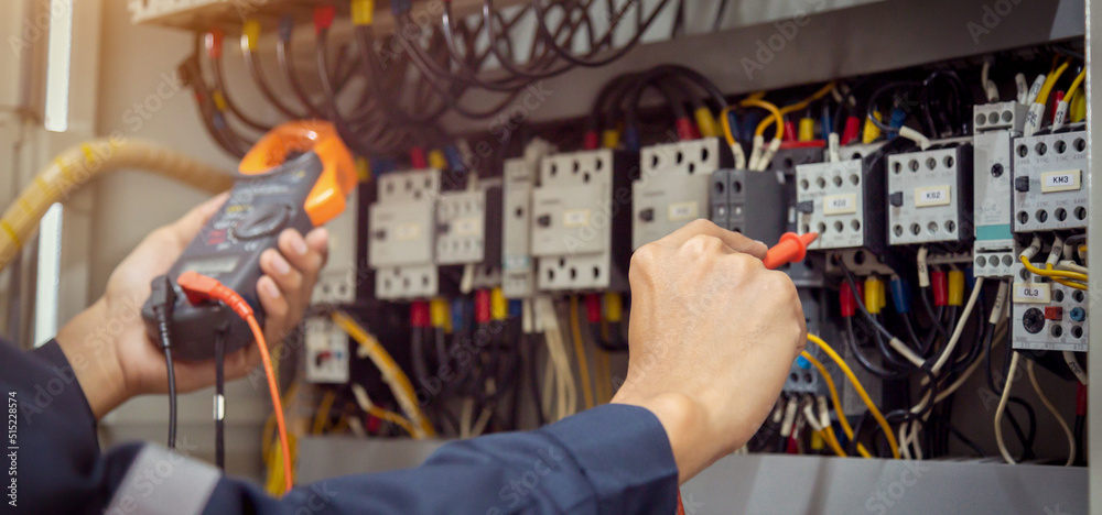Electrical engineer using measuring equipment to checking electric ...