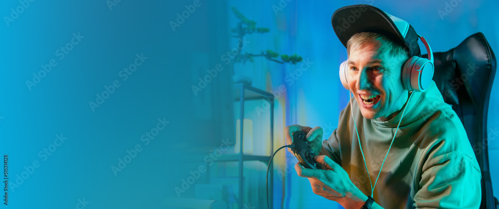 Pro Gamer Man playing computer games. Player using controller for ...