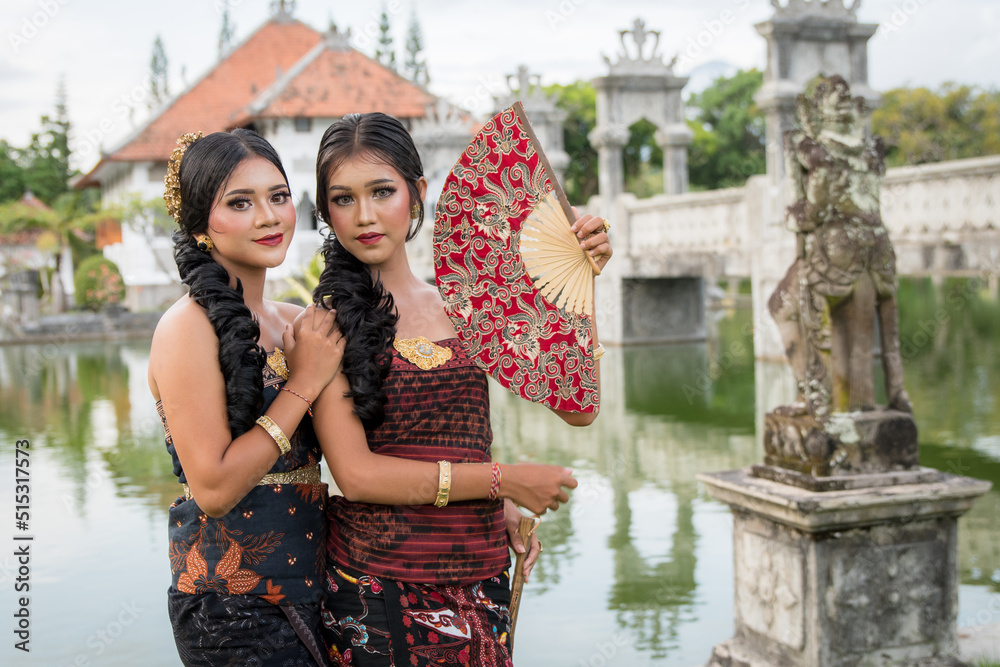 Beautiful girls in Balinese traditional dress with fan, Taman Ujung ...