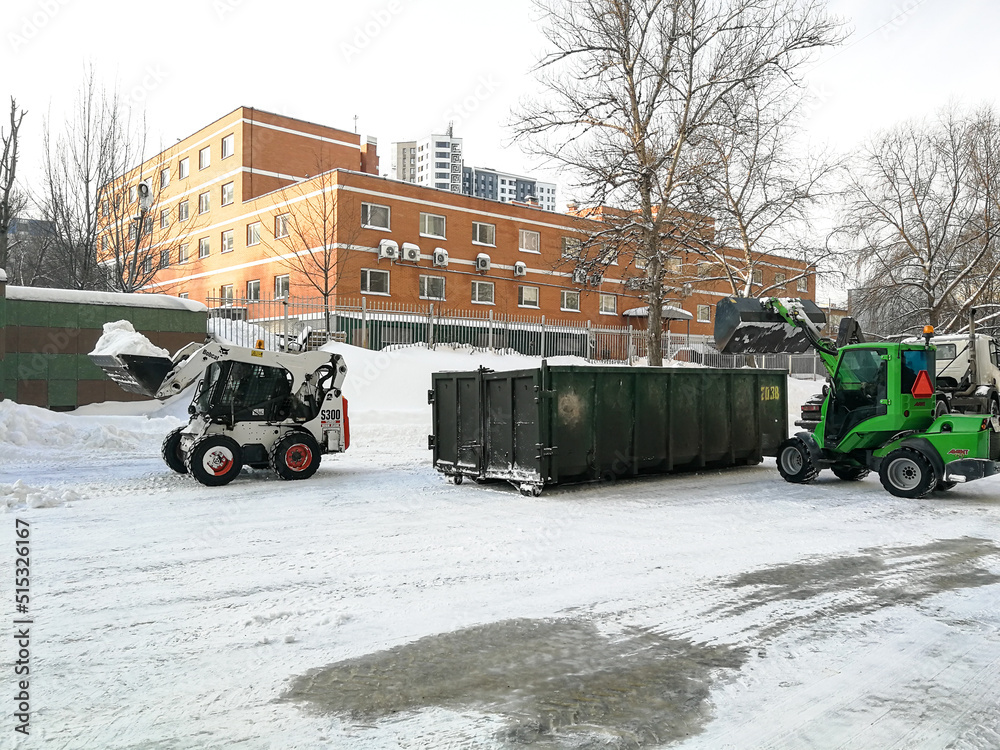 Moscow. Russia. January 15, 2021. Small front-end loaders clear snow ...