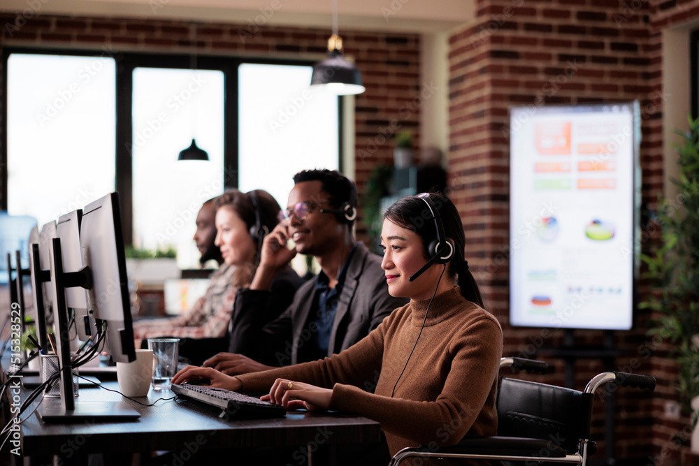 Paralyzed asian receptionist working at call center helpdesk in ...