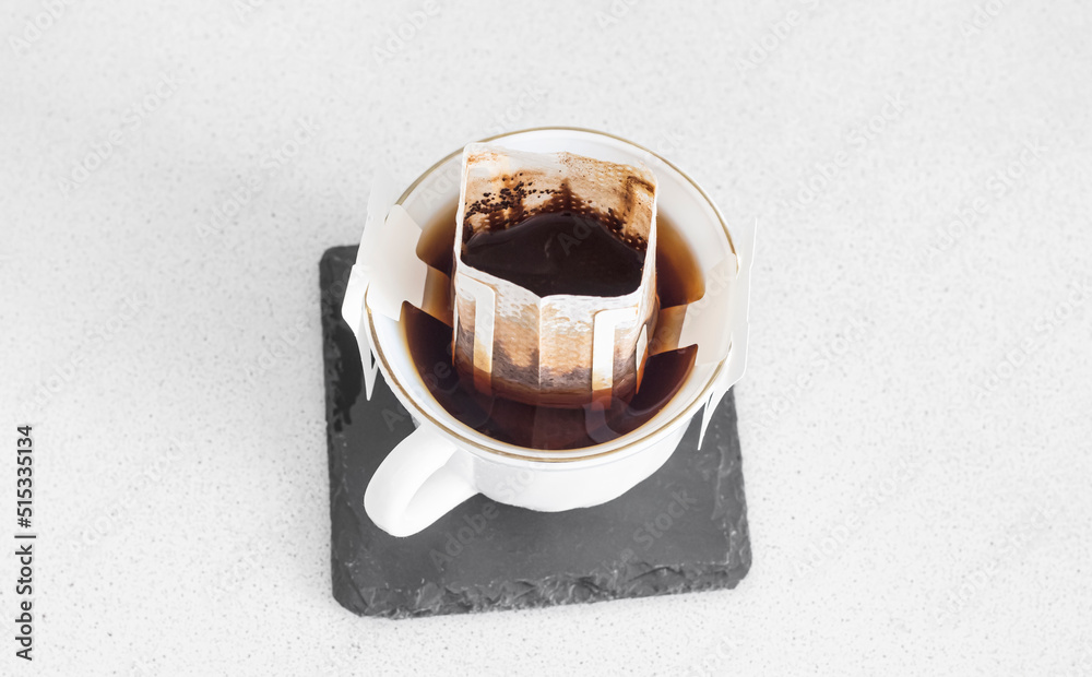 brewing process,a bag filled with boiling water for drip coffee in a ...