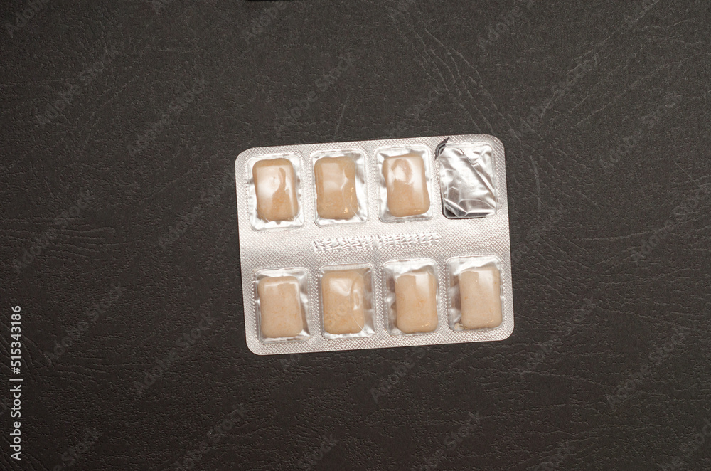 chewing gum in a blister on a dark background Stock Photo | Adobe Stock