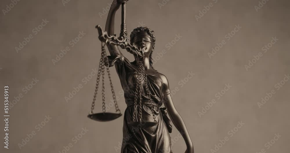 concept of law represented by blindfolded silhouette, bronze law statue ...