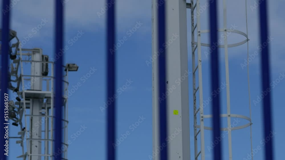 Ladder to a high steel rack. Tower with spotlights and cellular ...