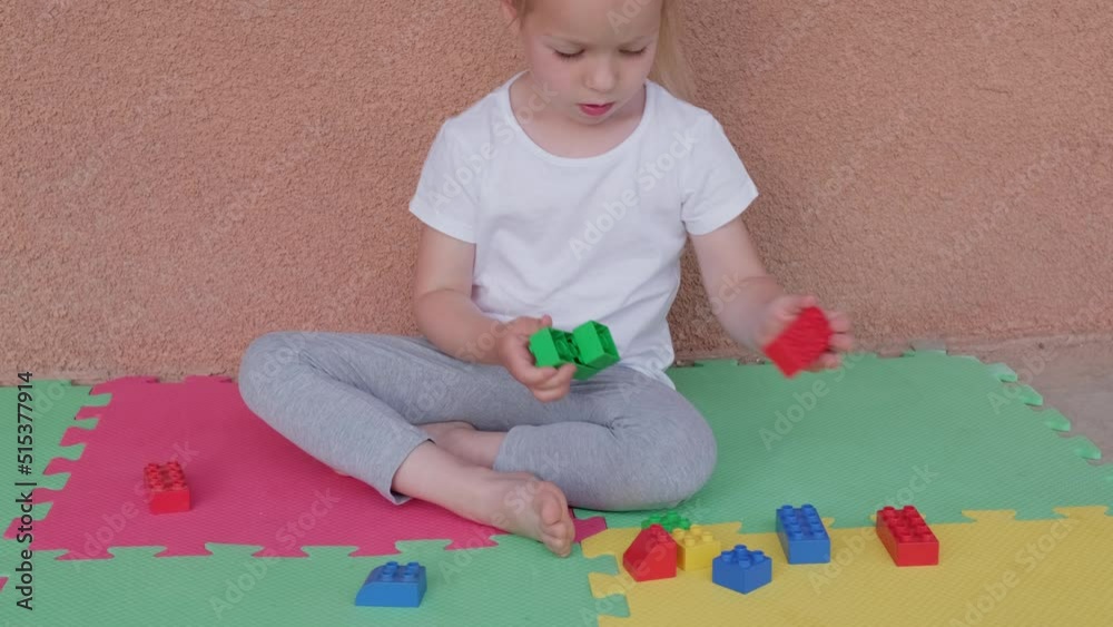 toddler little girl taking apart disassembling leggo constructor bricks ...