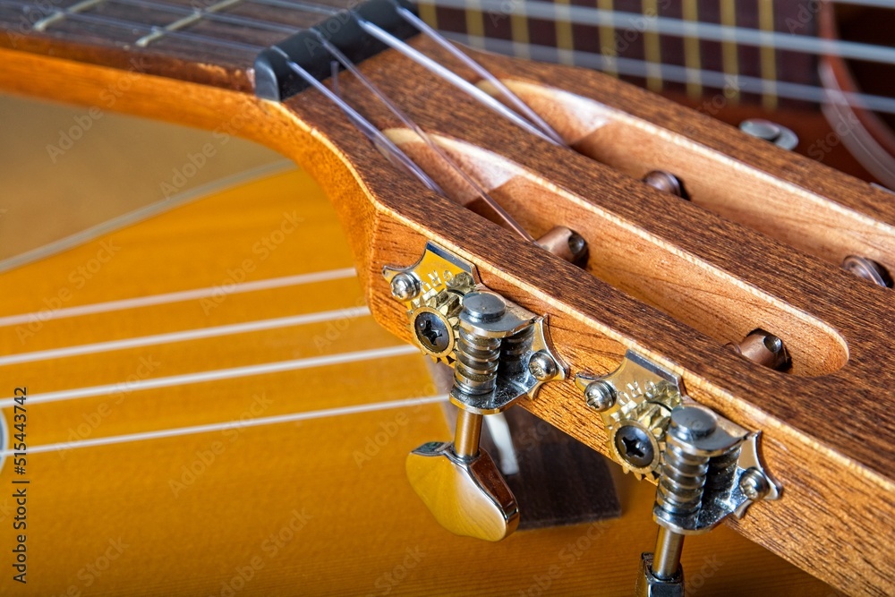 Collection of three ukuleles with an open headstock resting on a body ...
