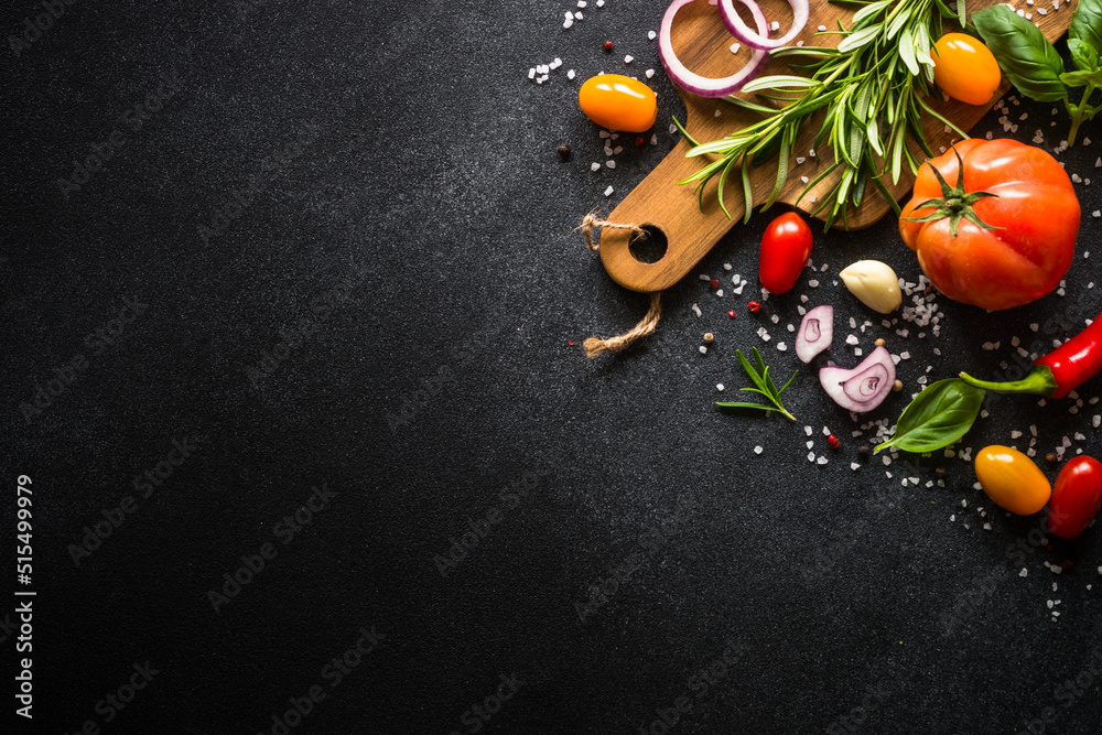 Food cooking background on black stone table. Fresh vegetables, herbs ...