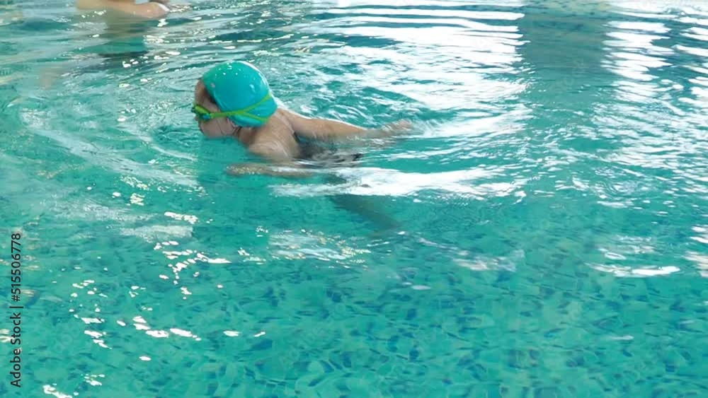 Little girl learning to swim with mother in big sport pool. Swimming ...