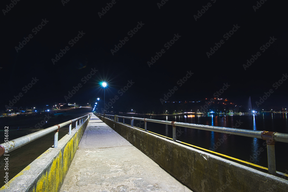 Waterfront path next to lake illuminated at night Stock Photo | Adobe Stock