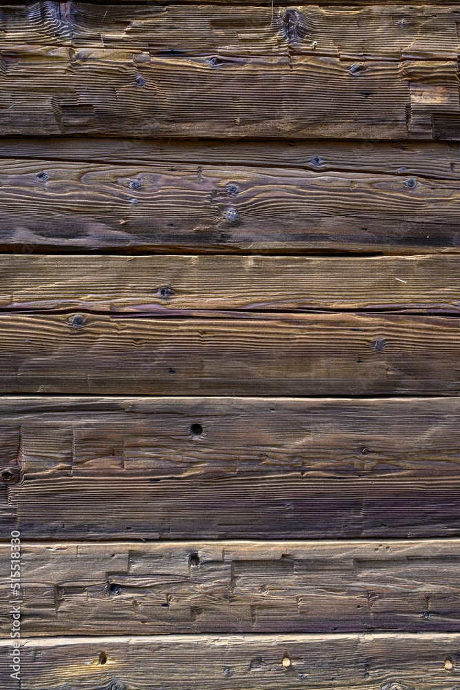 Wooden exterior of a rustic cabin built out of hand-hewn timber, as a ...