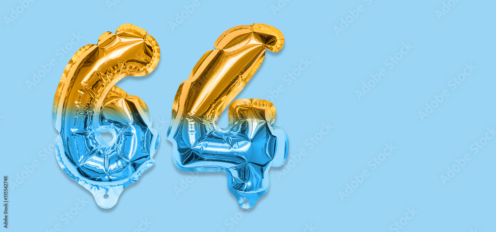 Rainbow foil balloon number, digit sixty four on a blue background ...