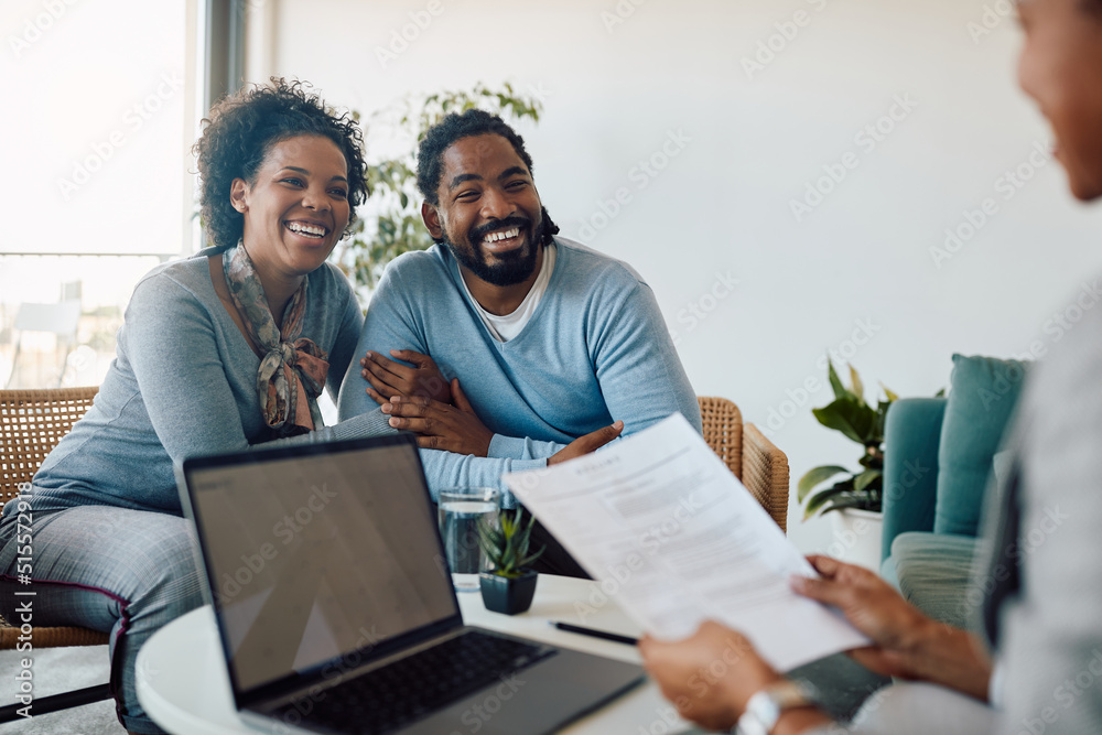 Happy black couple having meeting with their insurance agent in office ...