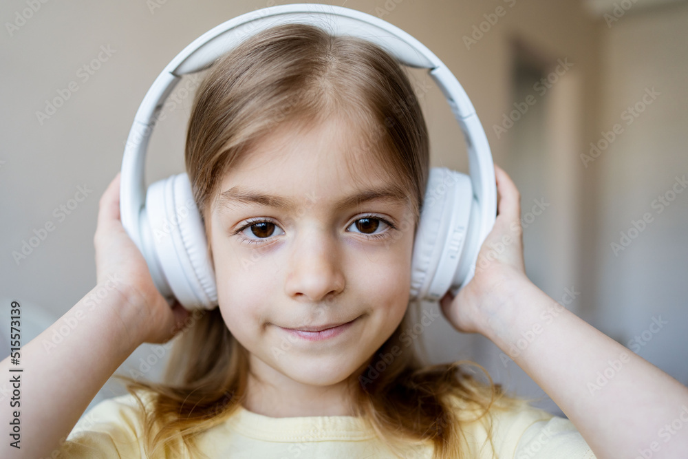 Cute child using headphones at home. Little kid girl having fun at home ...
