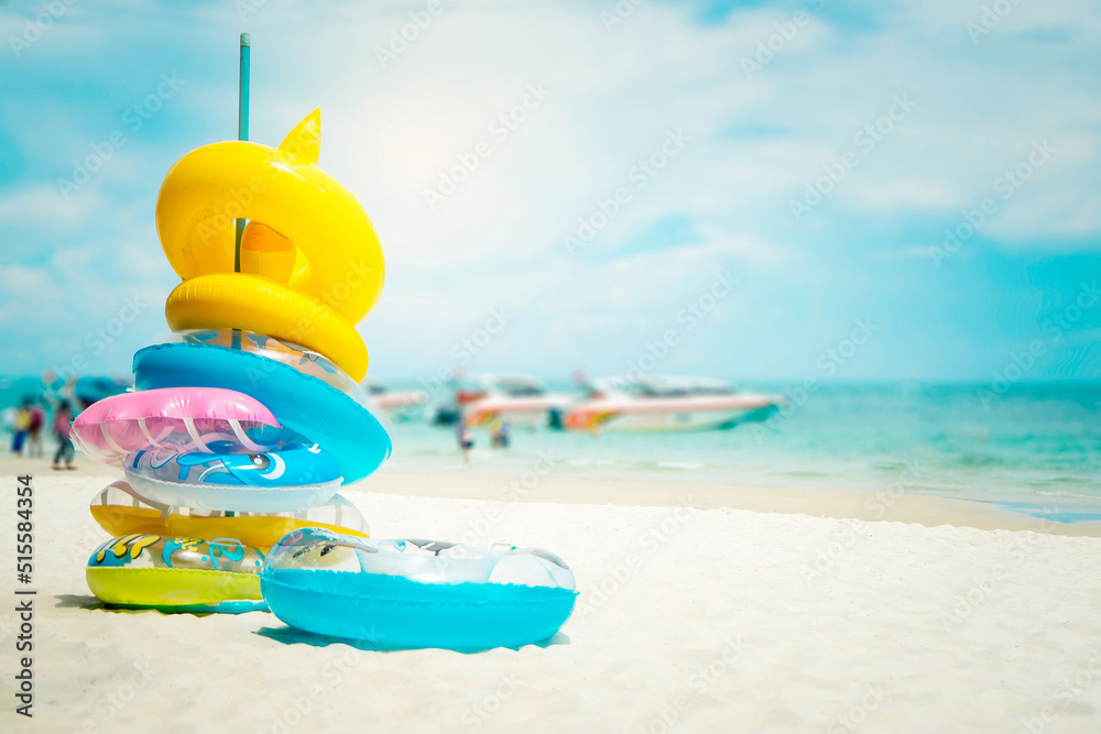 rubber rings on the sand. Fancy rubber swim rings on sand beach with ...