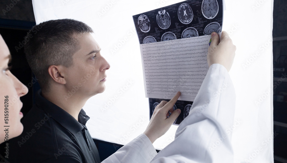 Epileptologist examines patient MRI and electroencephalogram. Concept ...