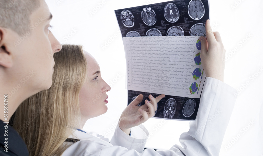 Epileptologist examines patient MRI and electroencephalogram. Concept ...