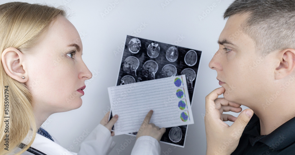Epileptologist examines patient MRI and electroencephalogram. Concept ...
