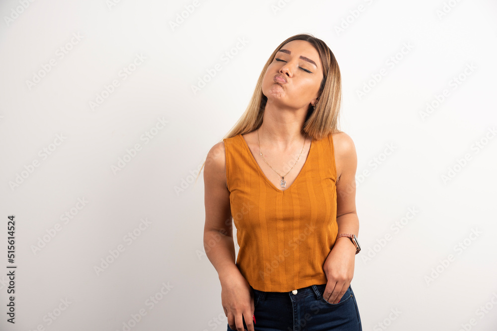 Funny woman puffed up her cheeks on white background Stock Photo ...