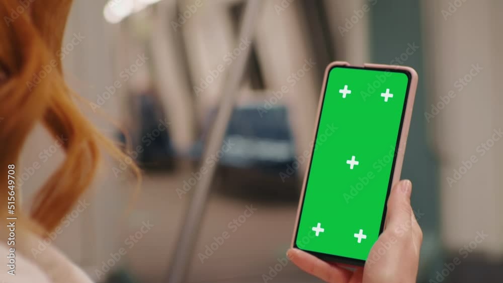 Vidéo Stock Close up woman watching on green screen phone in public ...