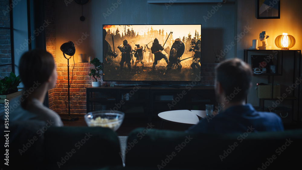 Authentic Couple Spending Time at Home, Sitting on a Couch and Watching ...