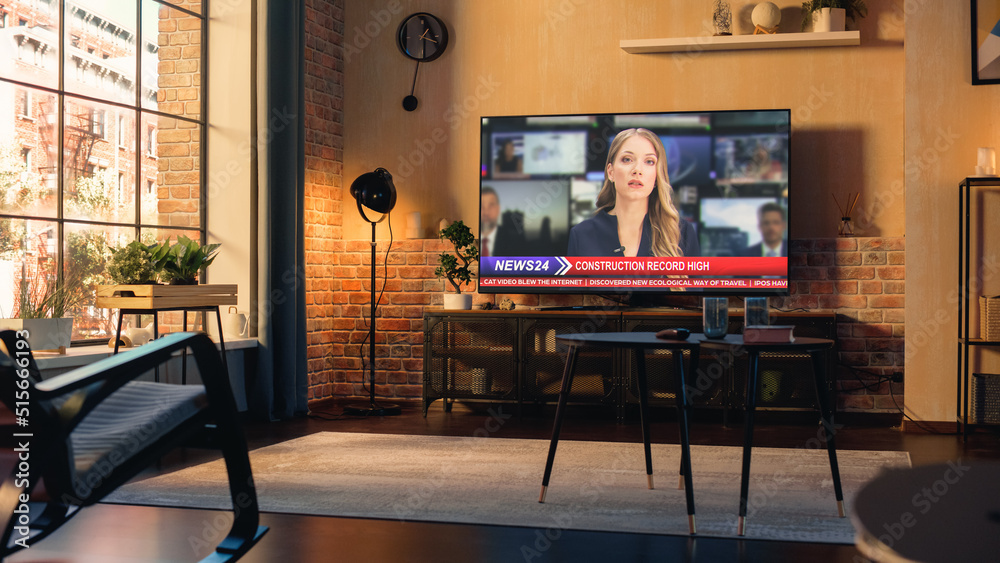 Stylish Loft Apartment Interior with Television News Program Playing ...