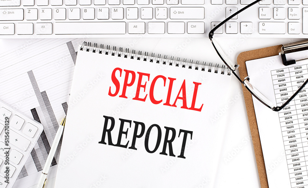 Text SPECIAL REPORT on Office desk table with keyboard, notepad and ...