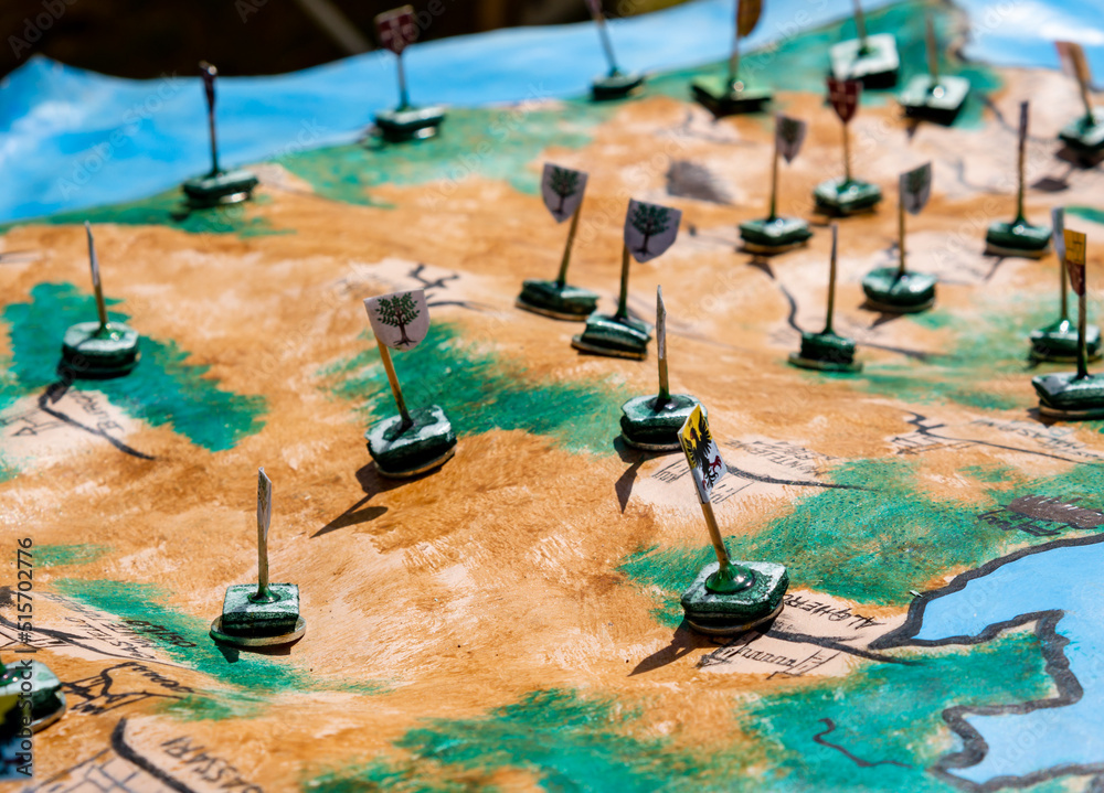 reproduction of an ancient medieval map with flags to mark the war ...