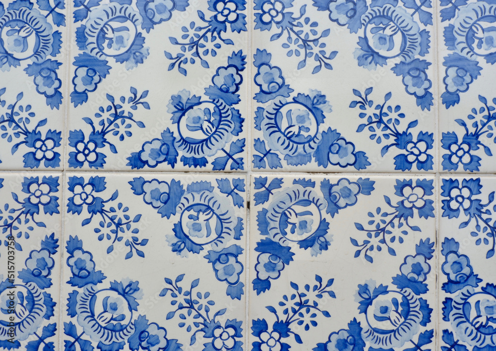 Tiled wall with traditional portuguese tiles of blue and white colours ...