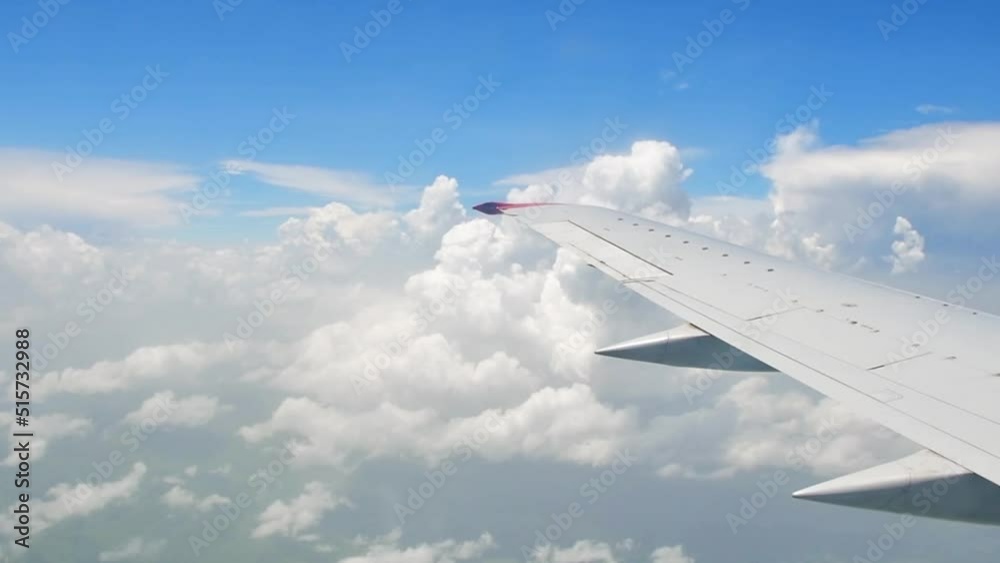Window view boeing passenger jet plane wing with passing beautiful ...
