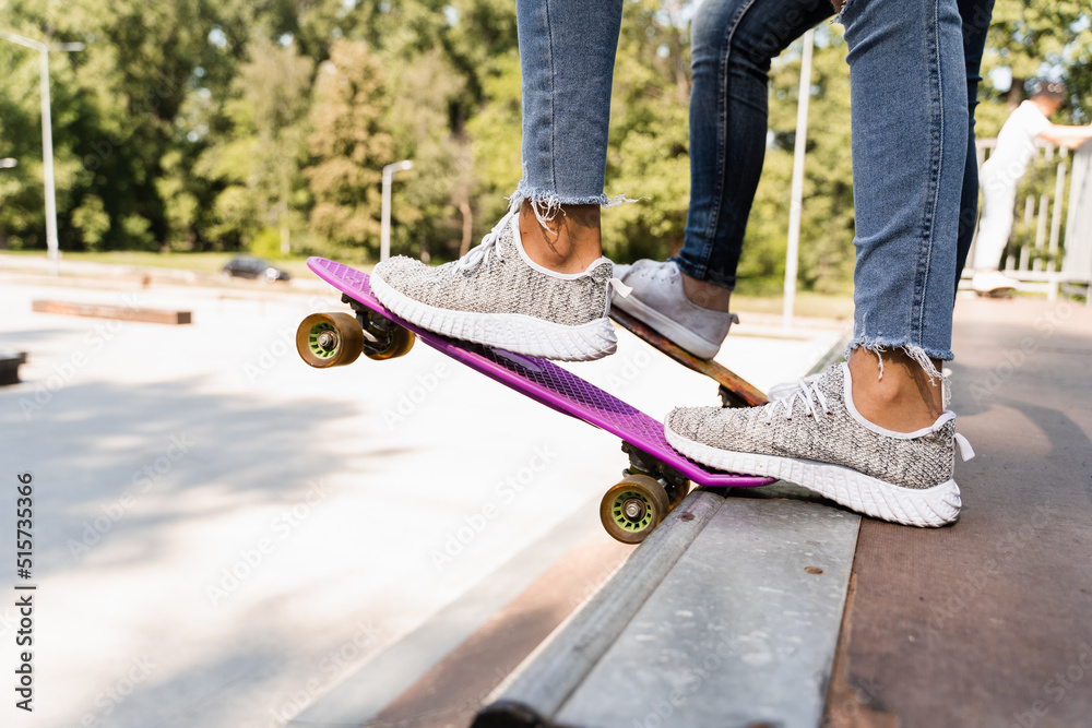 Children girls friends ready for ride on penny board on skateboard park ...