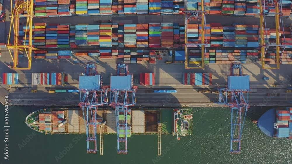 Loading and unloading a container ship in the port at the pier. Aerial ...