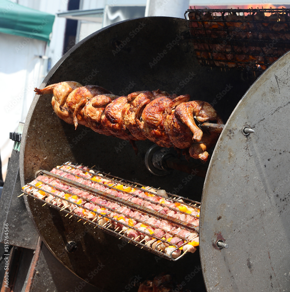 grilled with meat skewers and roast chickens spinning on a huge ...