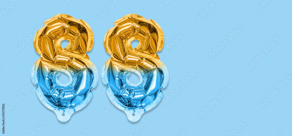 Rainbow foil balloon number, digit eighty eight on a blue background ...