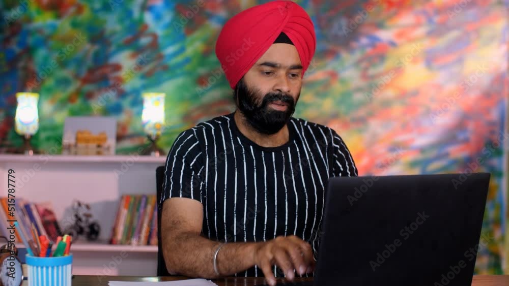 Video Stock A smart Indian guy in casual clothes and a red turban ...
