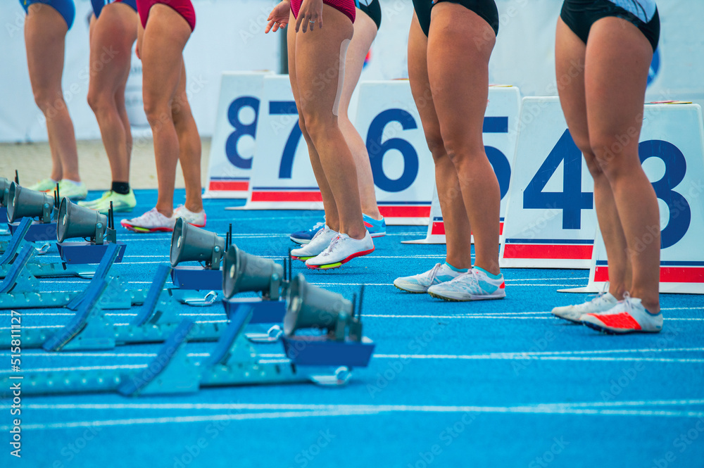 Track and field, running and sprinting. Legs of professional athletes ...