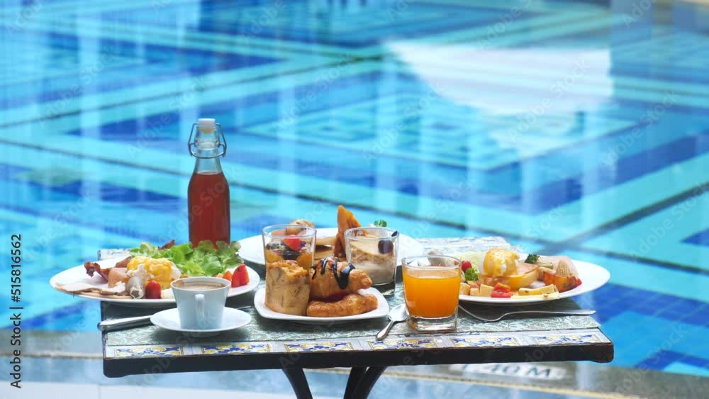 Breakfast served on terrace in outdoors poolside restaurant at luxury ...