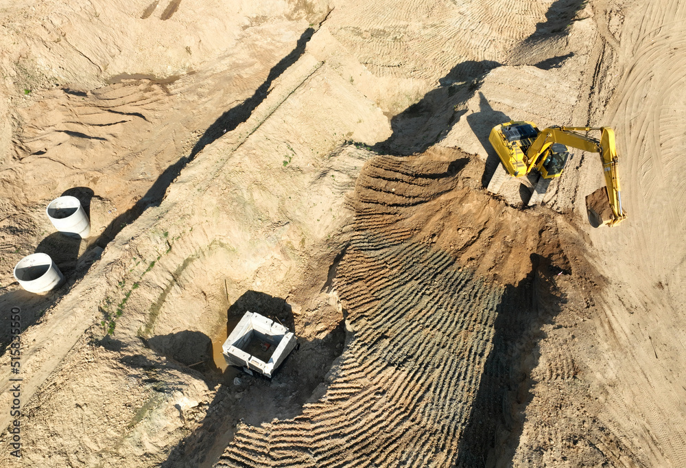 Excavator dig ground at construction site. Sewage drainage system ...