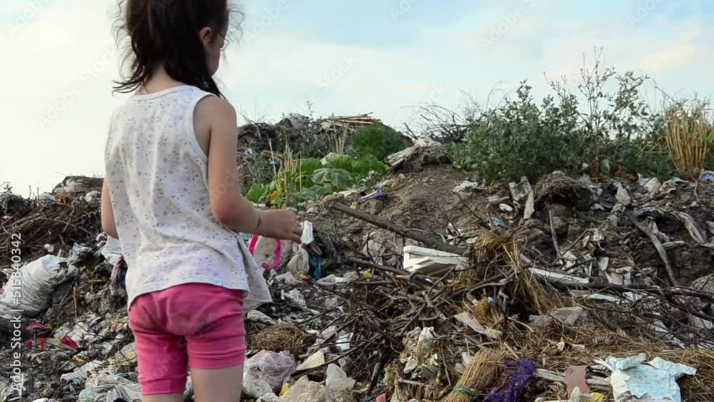 Children in the landfill. The child walks through the landfill. Ask for ...