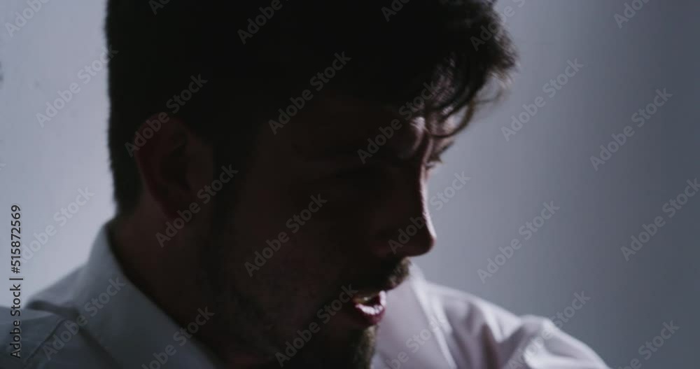 A businessman having a nervous breakdown on the floor and laughing ...